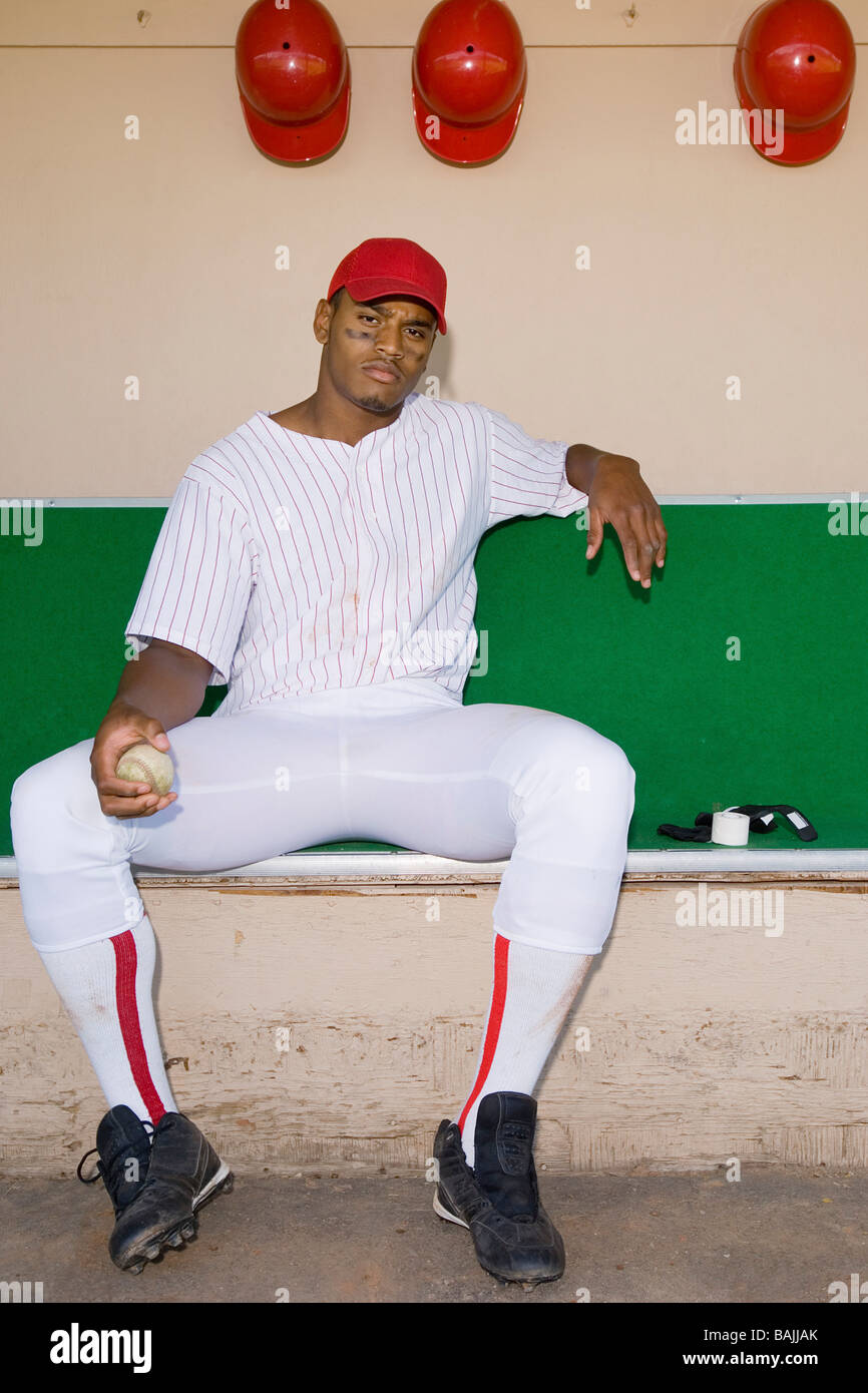 Baseball pitcher sitting in dugout, (portrait Stock Photo - Alamy
