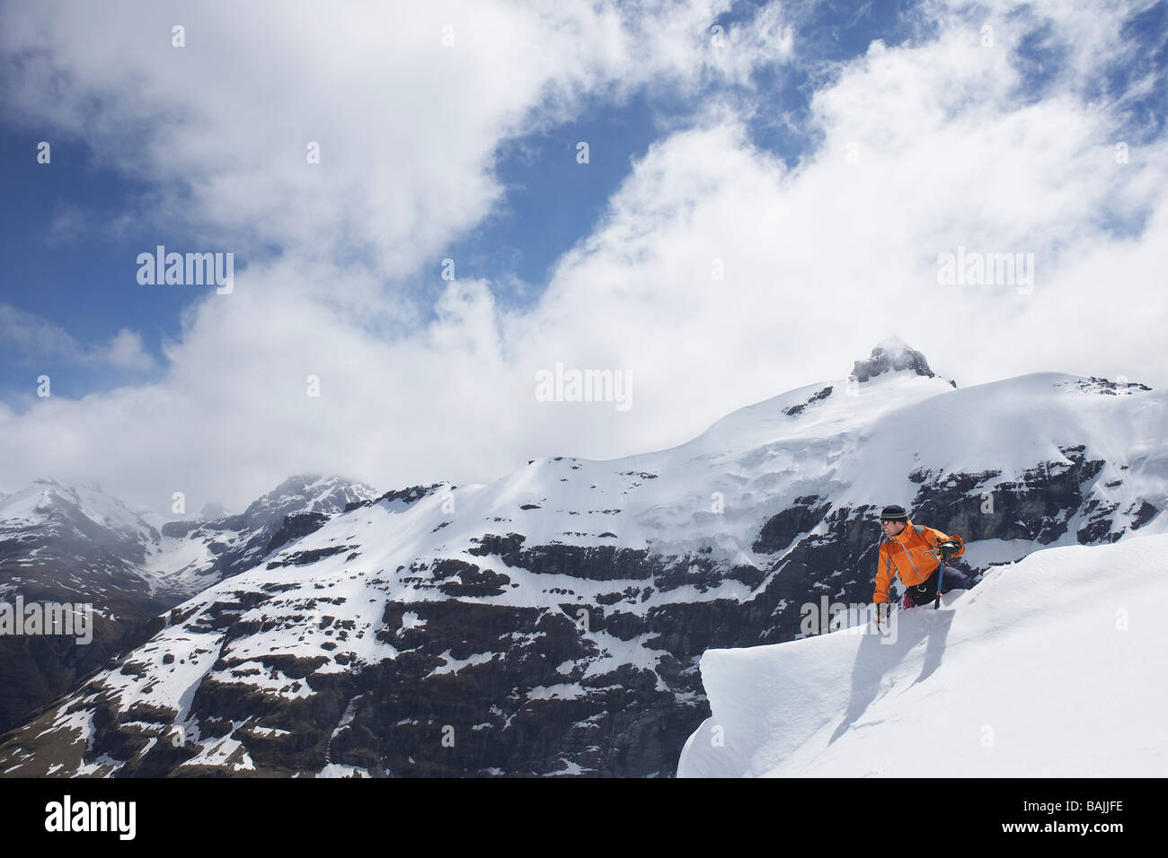 Mountain climber reaching peak Stock Photo - Alamy