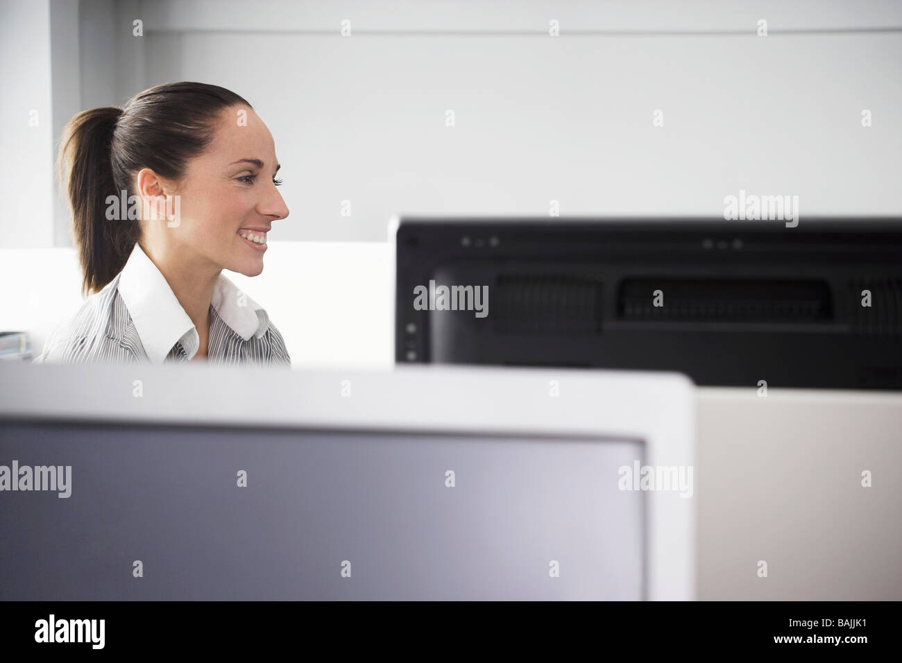 Female office worker sitting in office cubicle, smiling Stock Photo - Alamy