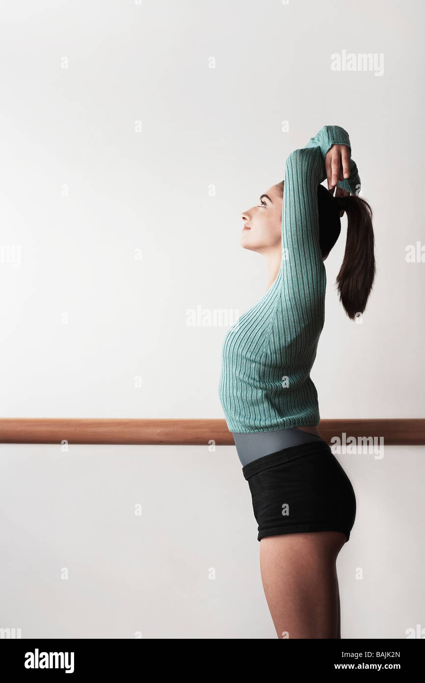 Young woman stretching arms overhead hi-res stock photography and ...