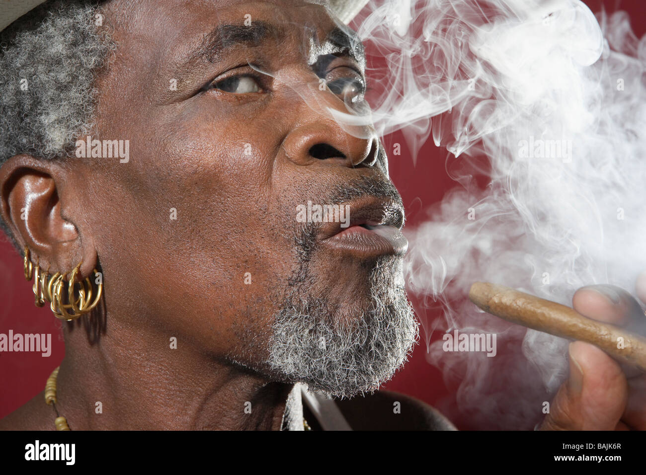 Man exhaling cigar smoke Stock Photo - Alamy