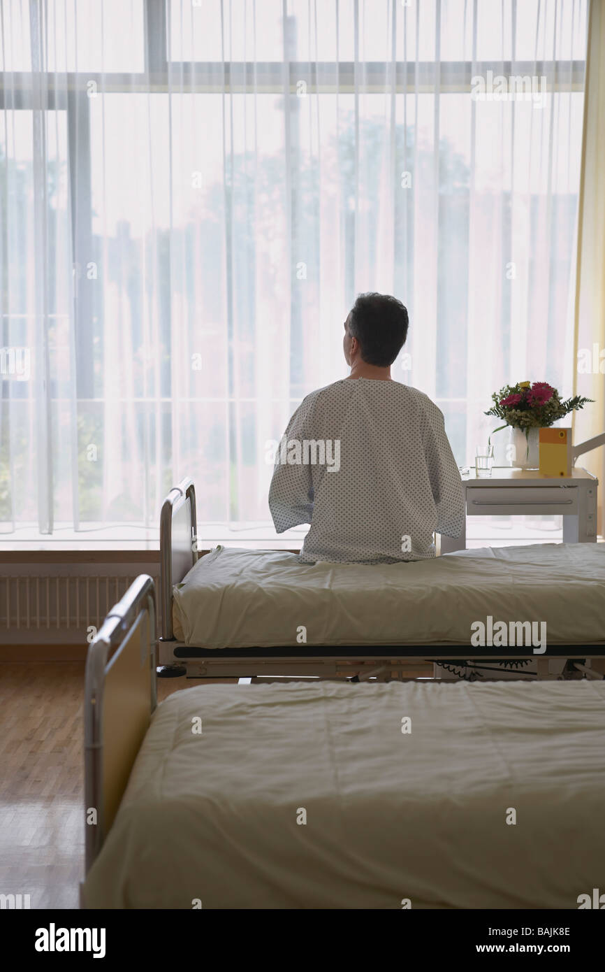 Patient Sitting on Hospital Bed, back view Stock Photo - Alamy