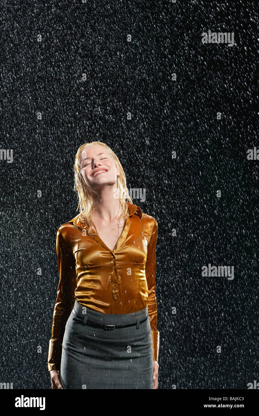 Woman Standing in Rain, letting raindrops fall on face Stock Photo - Alamy