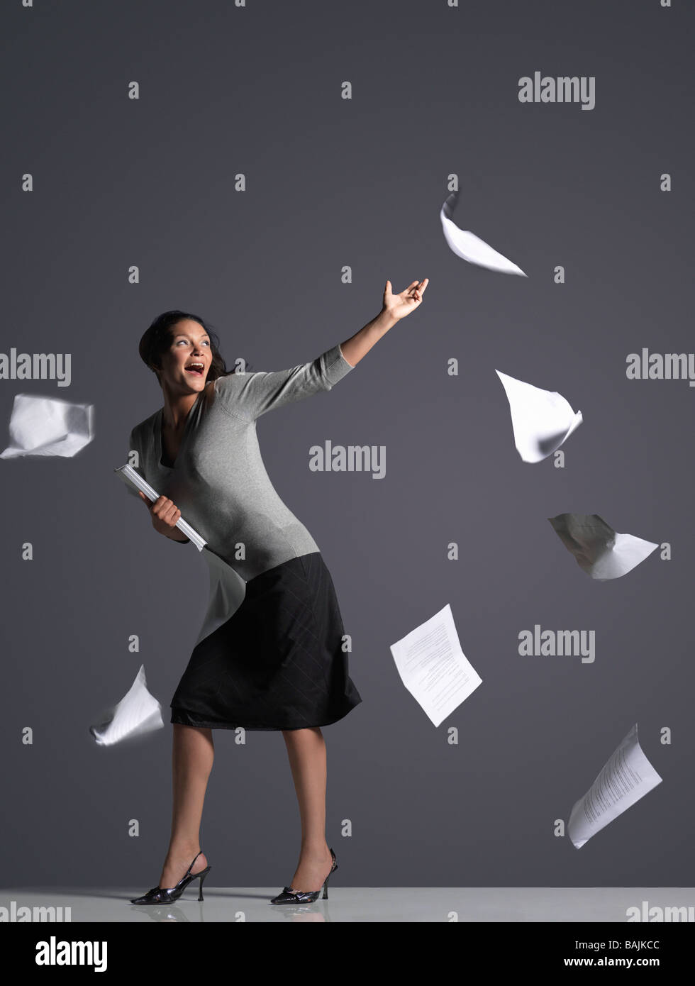 Young Businesswoman with Scattering Papers, side view Stock Photo - Alamy