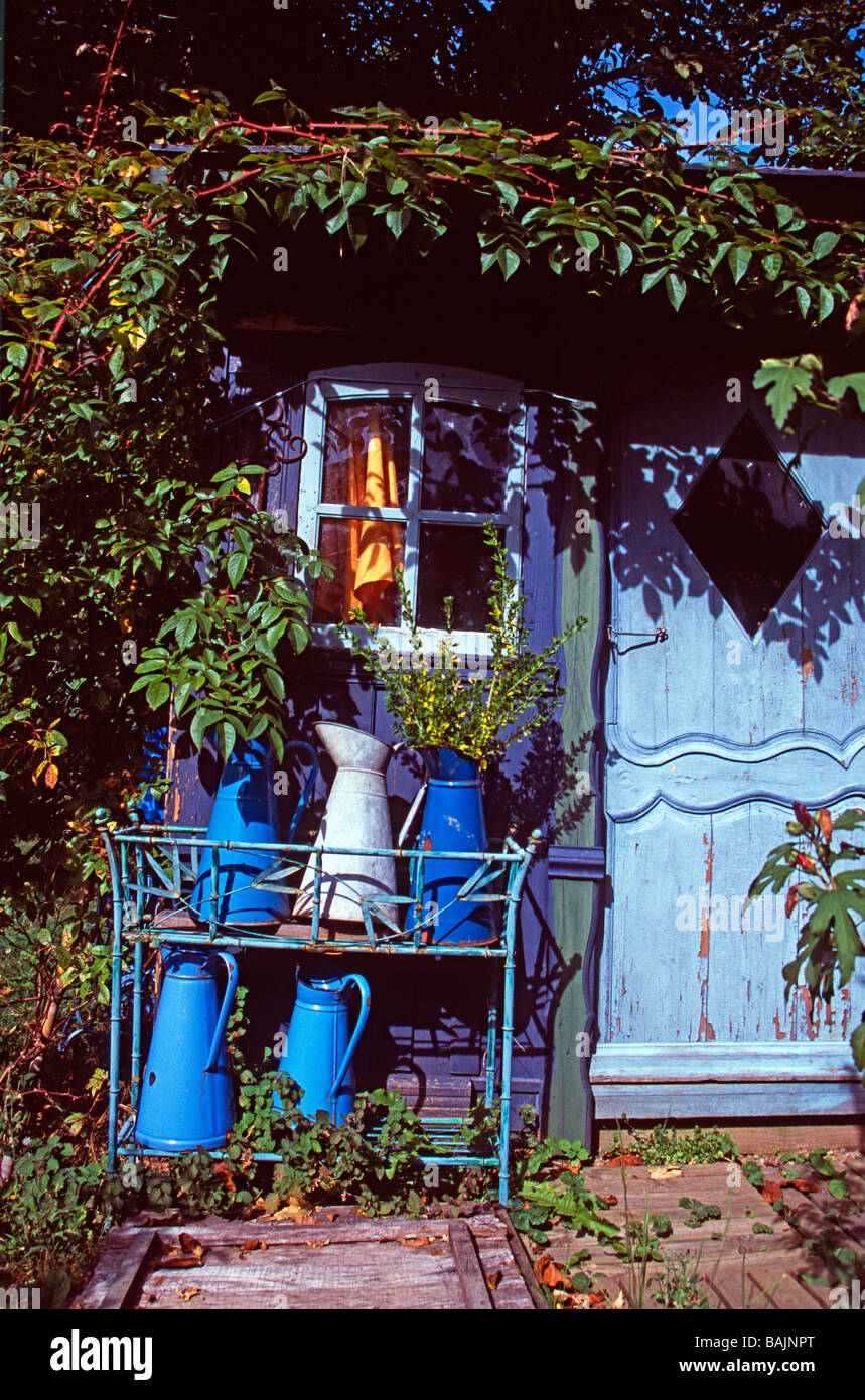 Vintage blue enamel jugs outside rustic garden shed, Crozillac, Aveyron ...