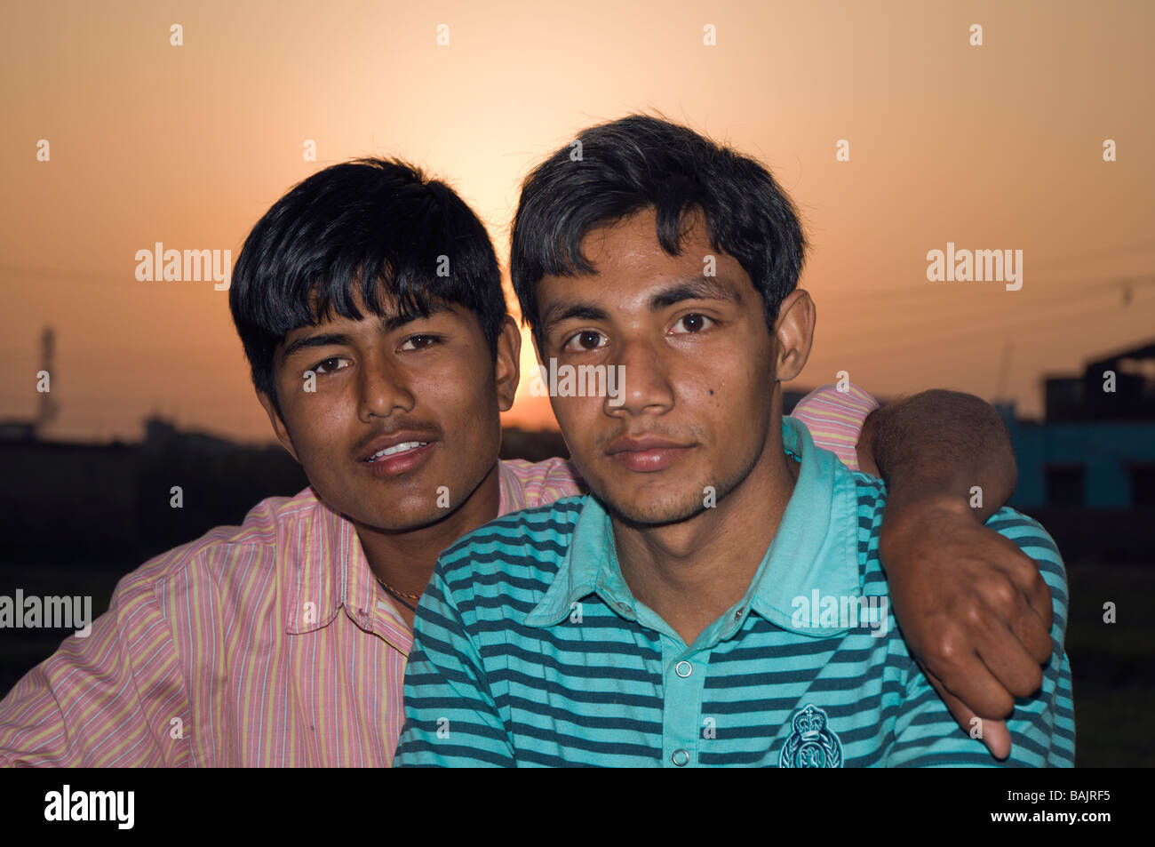 two nepali boys pose with sunset in background Stock Photo - Alamy