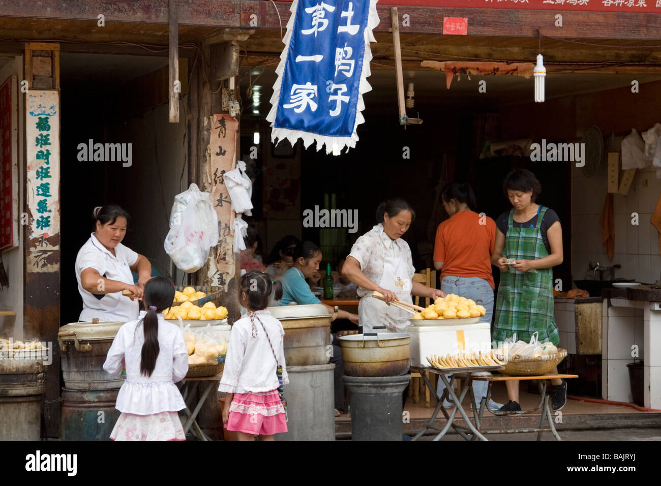 People shopping for rustic foods at an eatery in the main square of ...