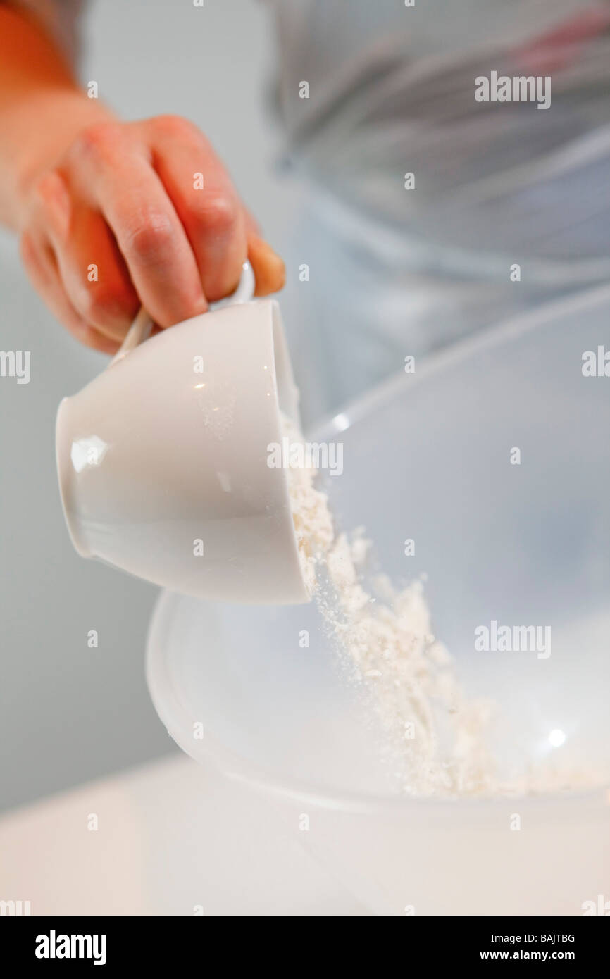 adding flur to baking mixture Stock Photo - Alamy