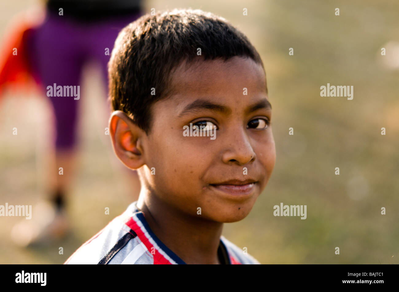 nepali boy stares into camera during a game of football Stock Photo - Alamy