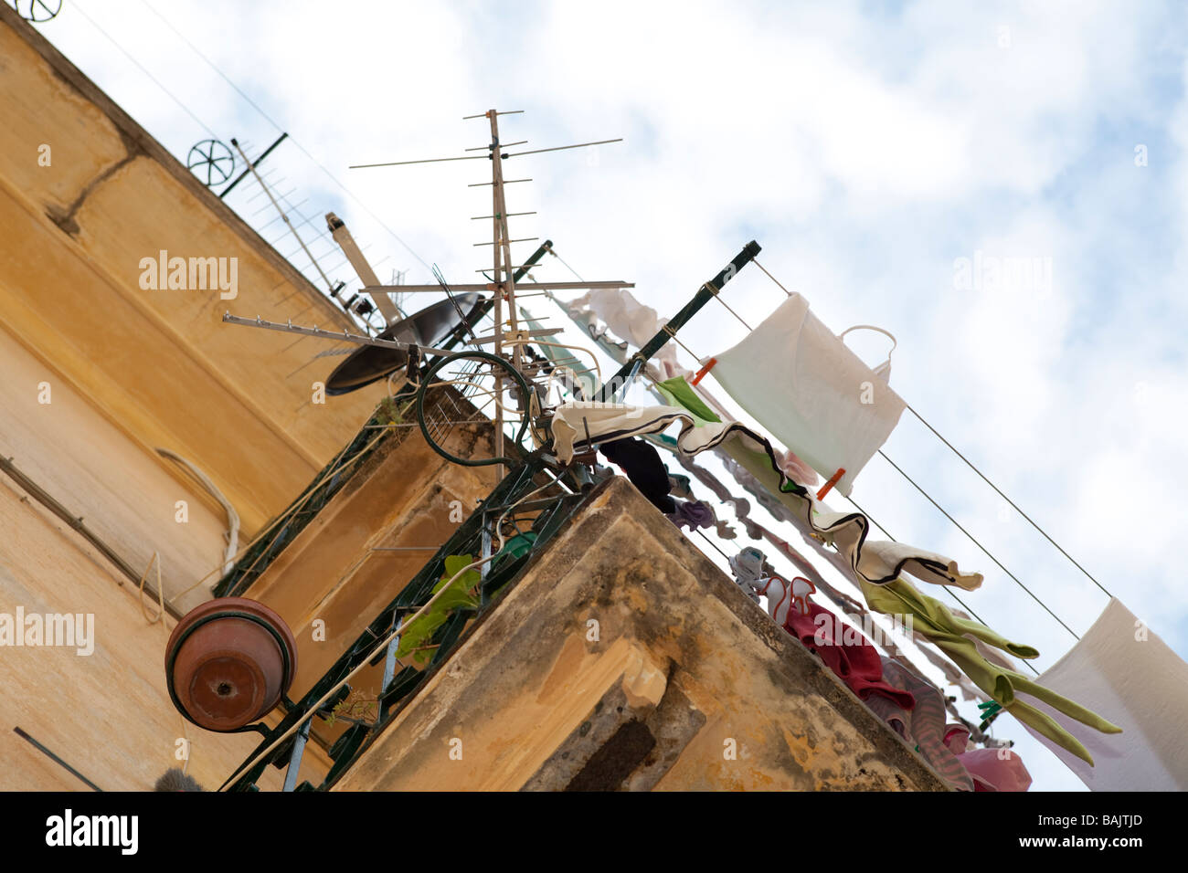 Laundry hanging from a clothesline at a balcony of an old house in ...