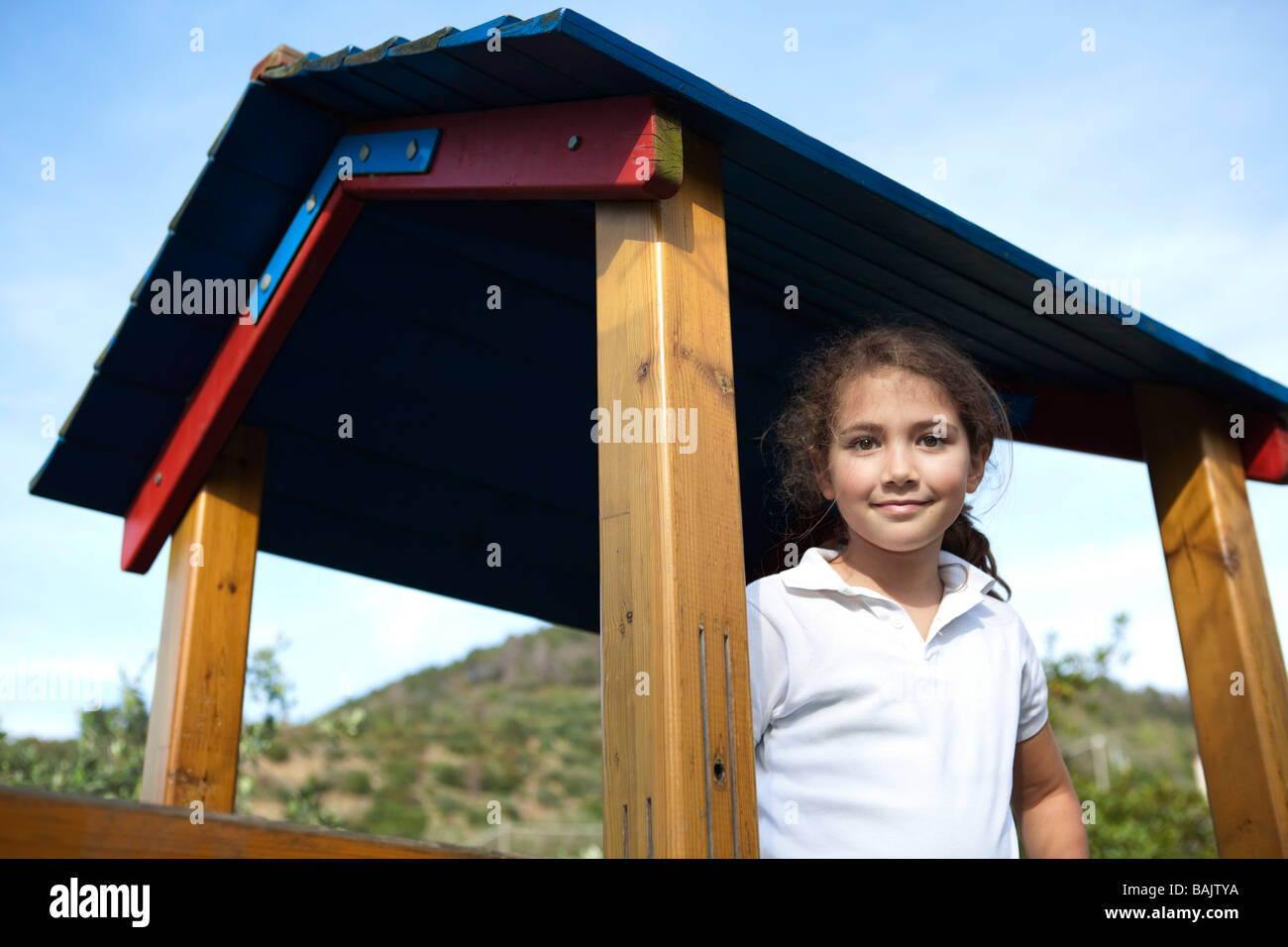 Beautiful child playing alone under a playground roof Stock Photo - Alamy