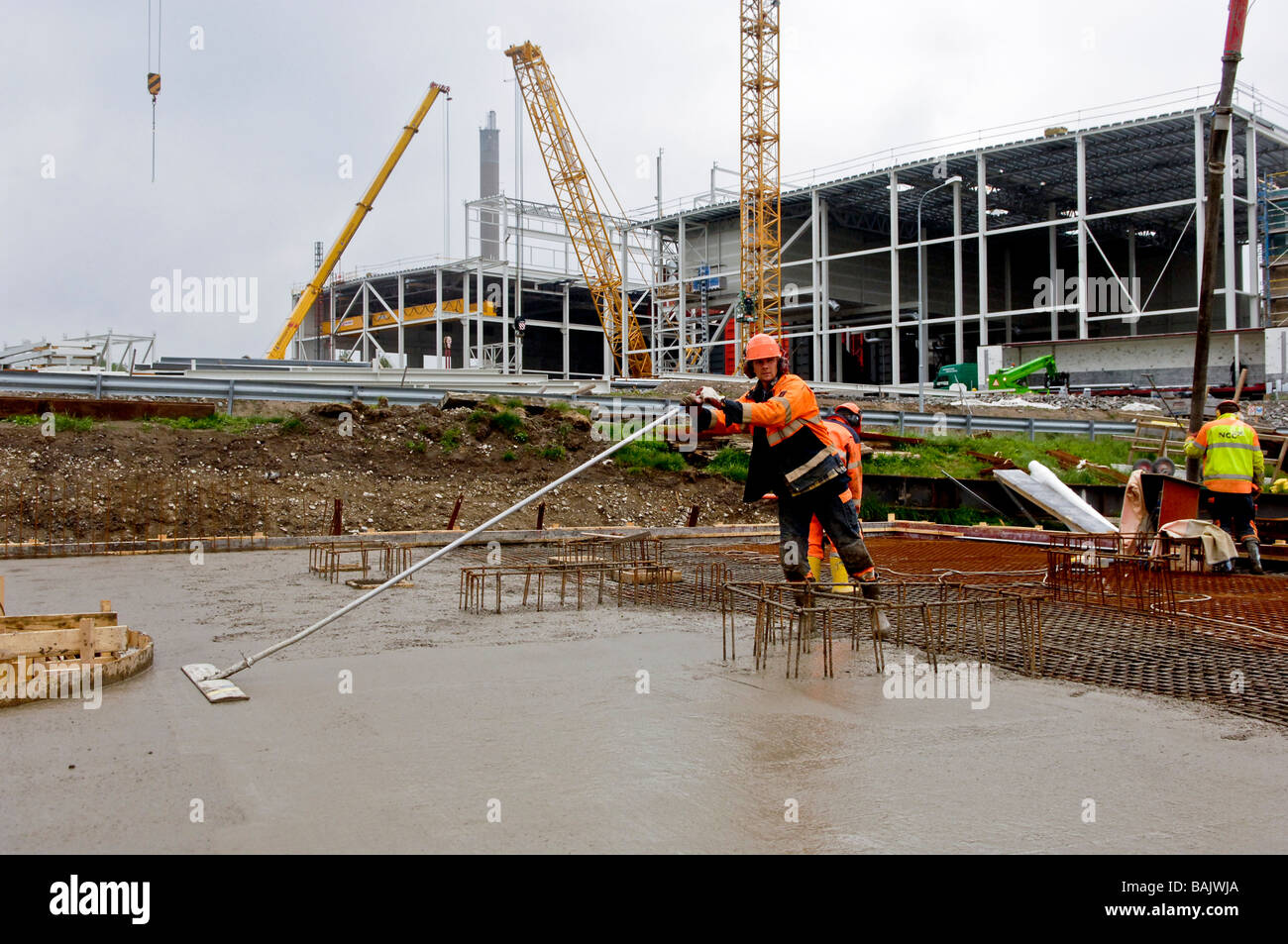 Construction worker evens out a layer of fresh concrete Stock Photo - Alamy