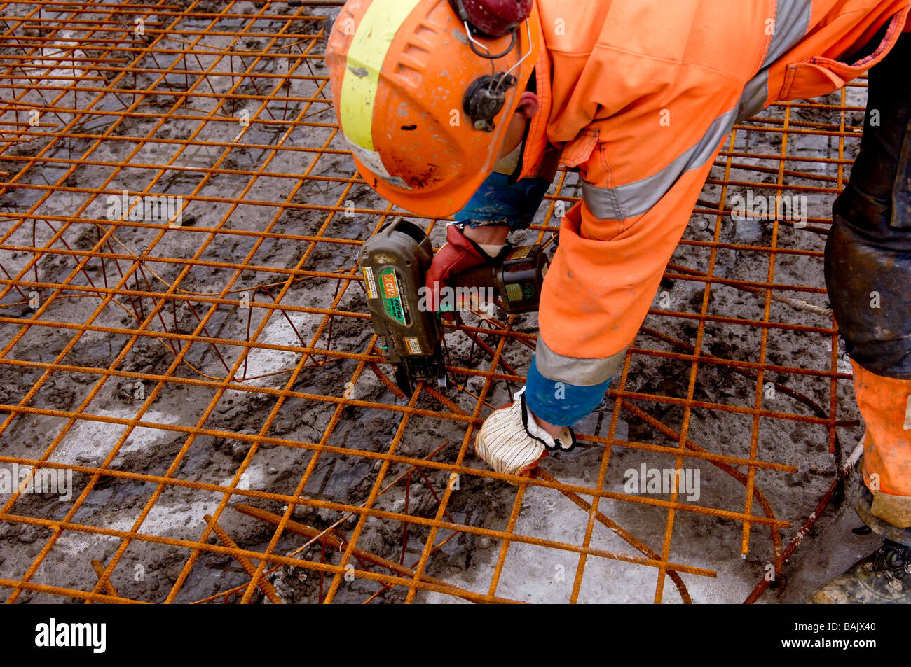 Construction workers putting reinforcement rods together before pouring ...