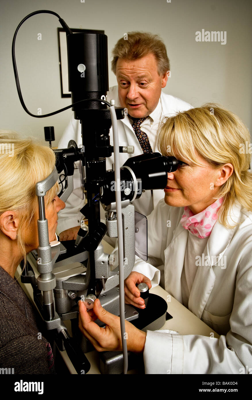 A nurse examine a patients eyes under supervision of a doctor Stock ...