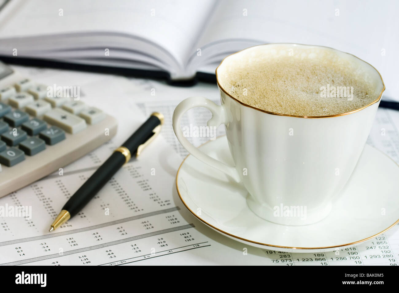 Cup of coffee and financial accounting Stock Photo - Alamy