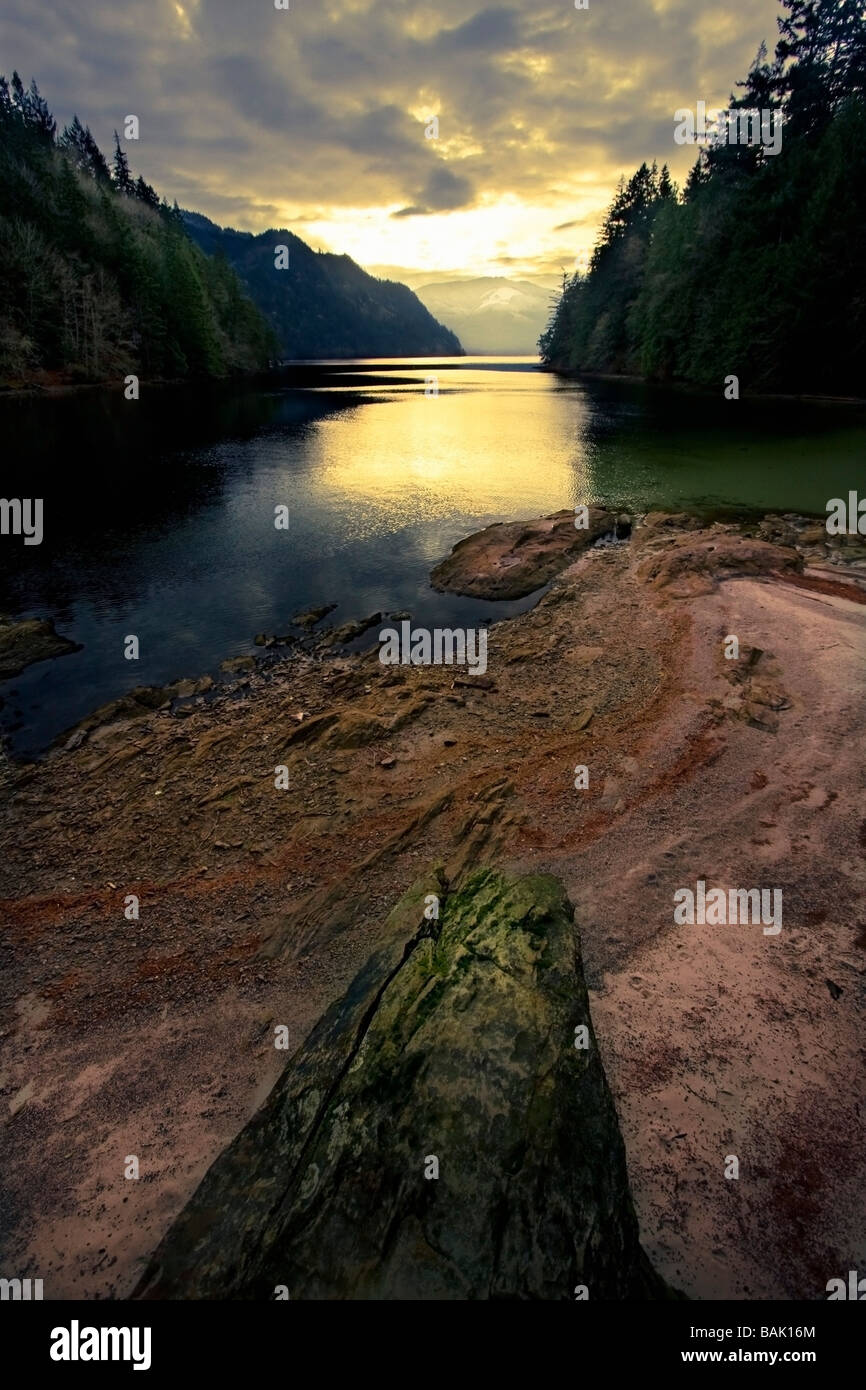 Sun setting on a river Stock Photo - Alamy