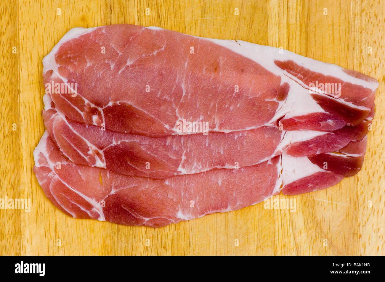 Three Rashers slices of Uncooked Raw Back Bacon Stock Photo - Alamy