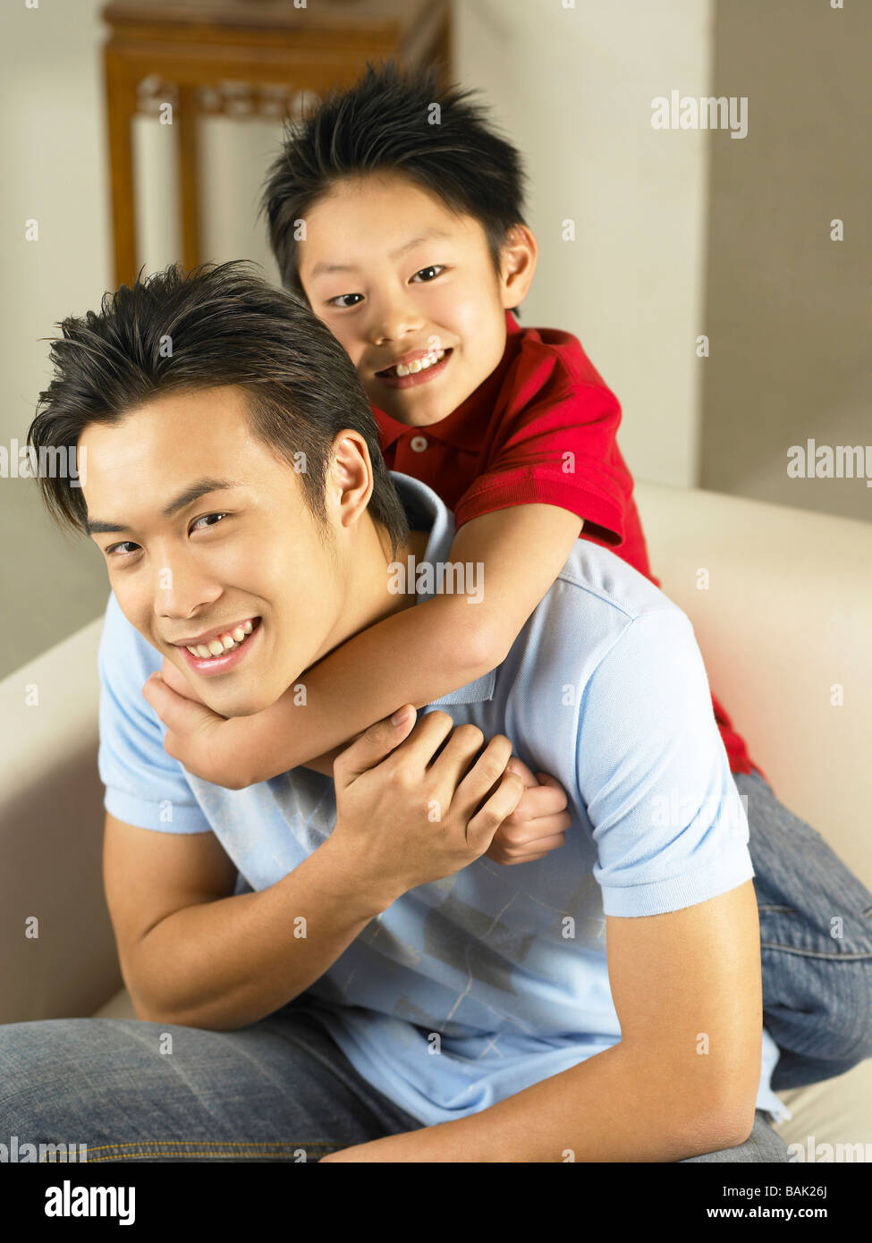 a boy arm around father s shoulders happily Stock Photo - Alamy