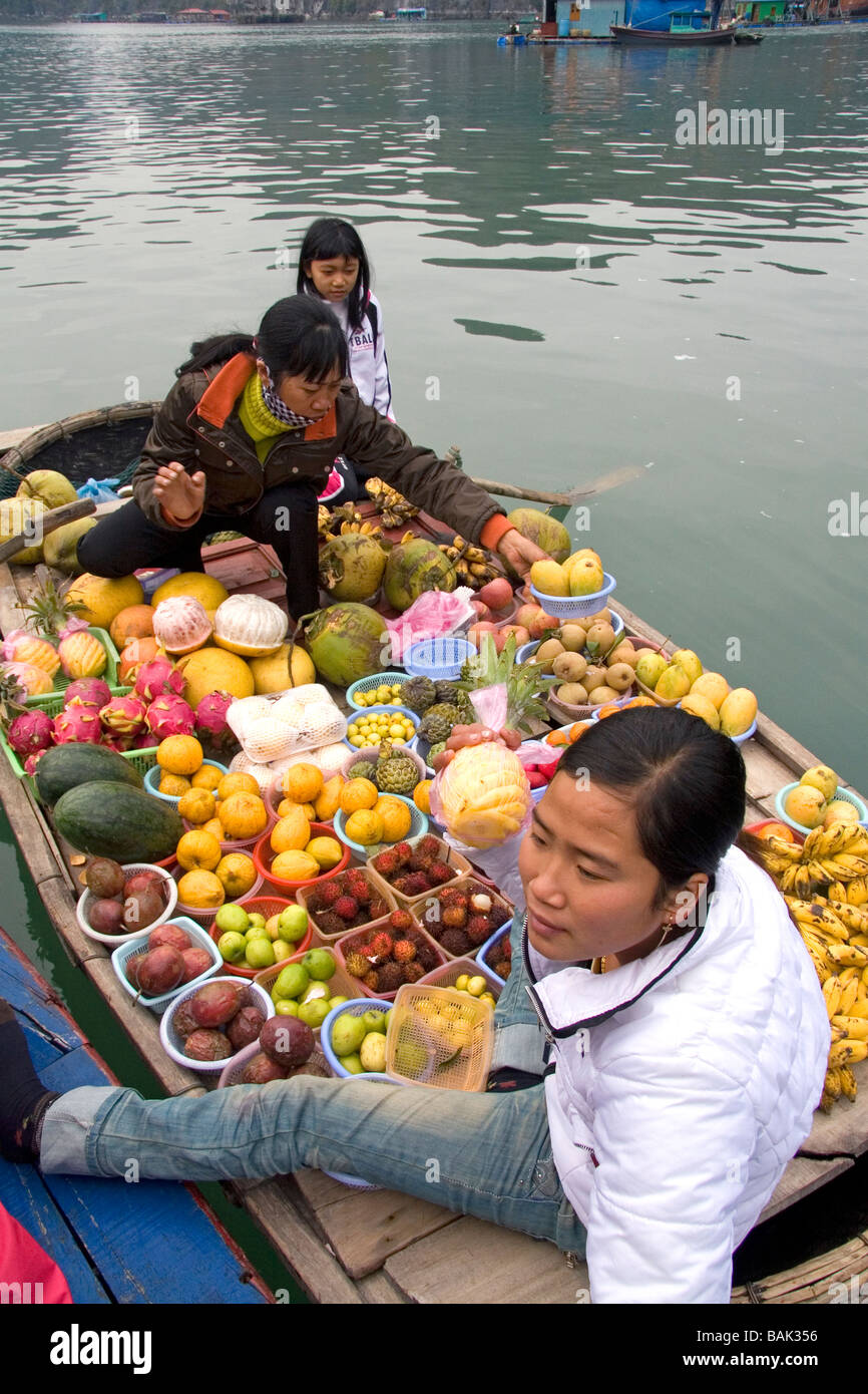 Vietnamese boat vendors selling fruit in Ha Long Bay Vietnam Stock ...