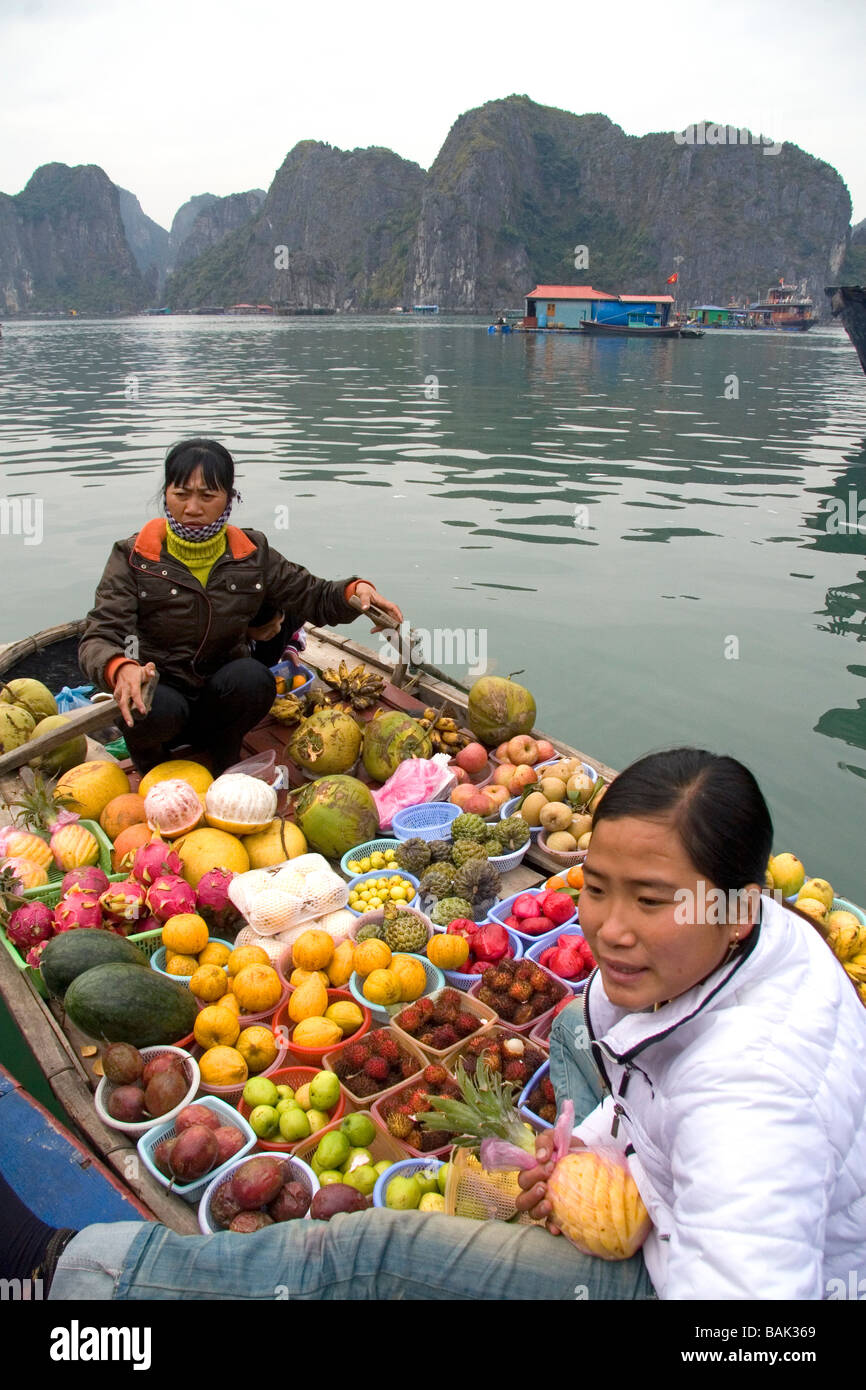 Vietnamese boat vendors selling fruit in Ha Long Bay Vietnam Stock ...