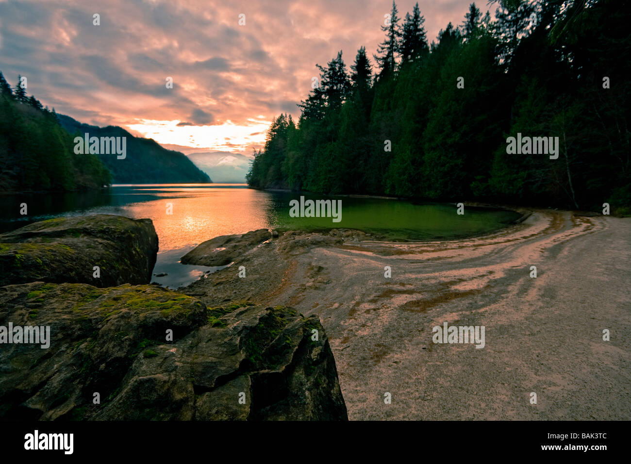 Sun setting on a river Stock Photo - Alamy