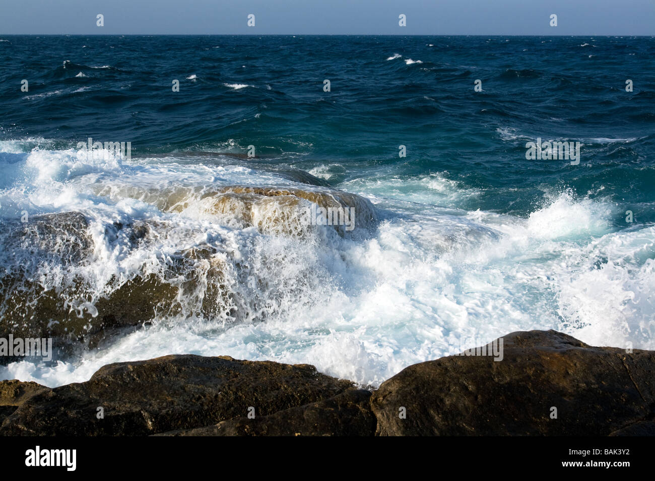 Waves spalshing against rocks Stock Photo - Alamy