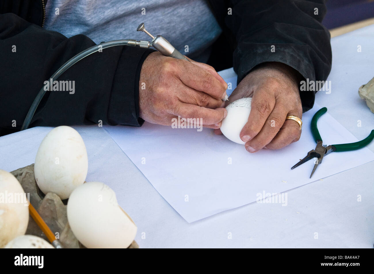 egg carver displays craft at street fair Stock Photo - Alamy