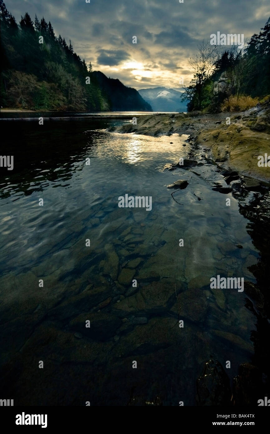 Sun setting on a river Stock Photo - Alamy