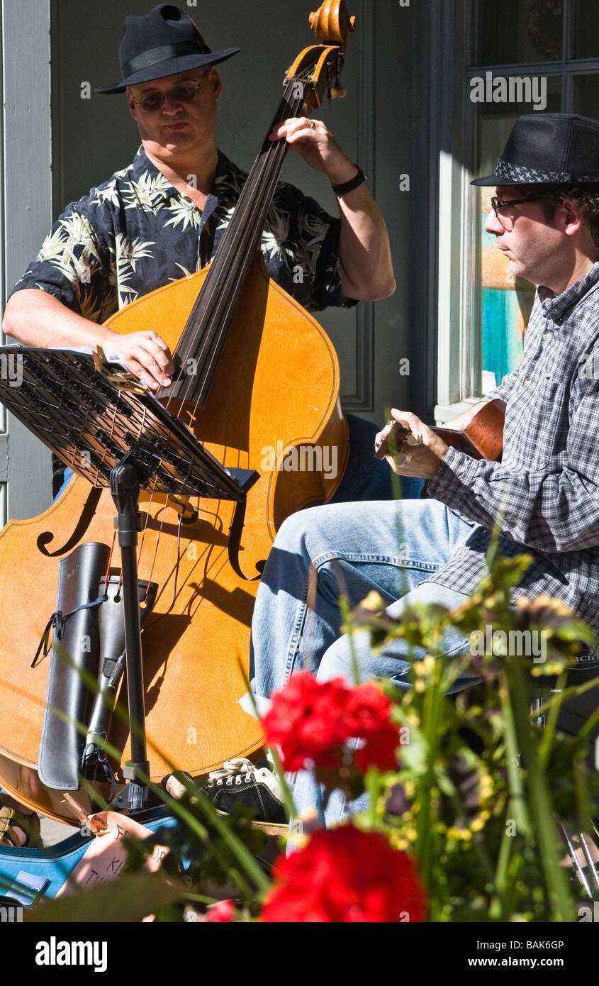 Two musicians play music at city street fair Stock Photo - Alamy