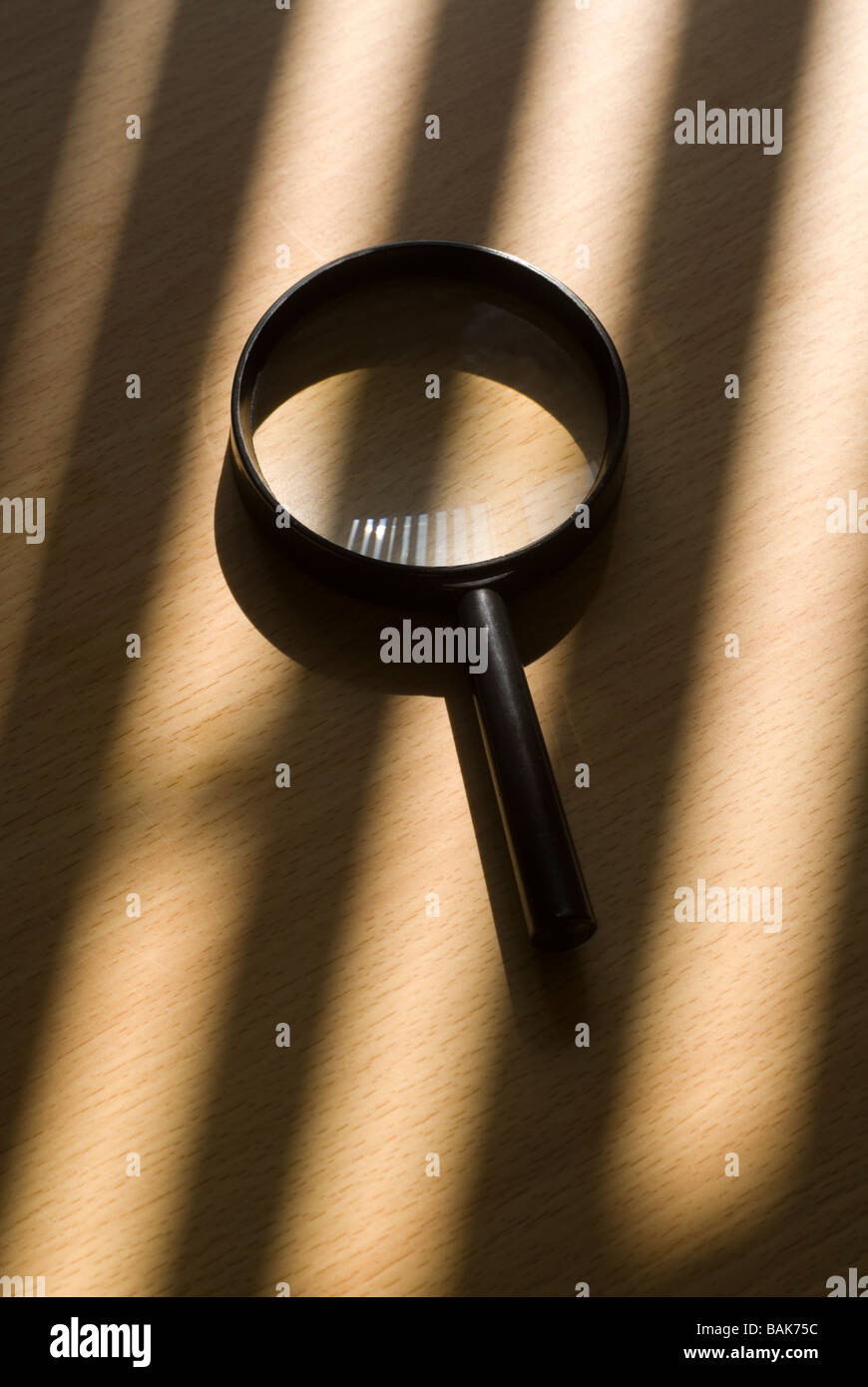 Magnifying glass by the window light Stock Photo - Alamy