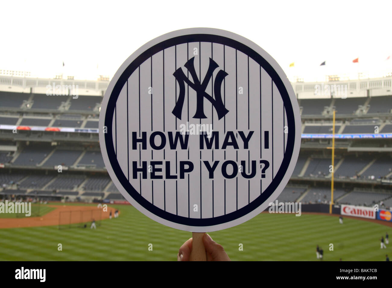 Close up of a "how may I help you" sign held by workers inside the new ...