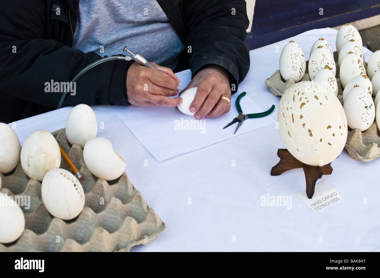 egg carver displays craft at street fair Stock Photo - Alamy