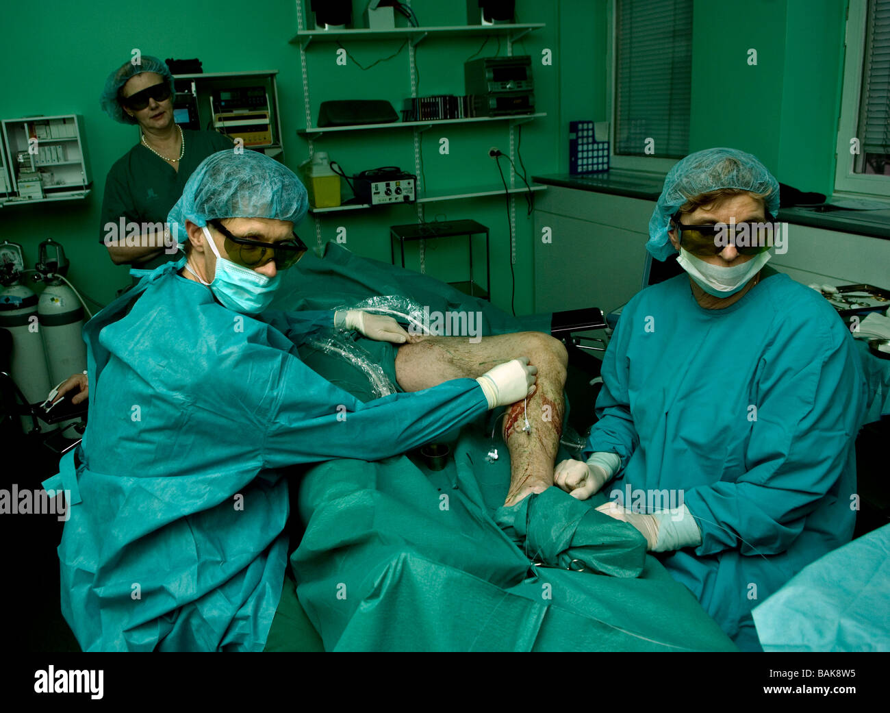 Surgeon does surgery on varicose veins with laser Stock Photo - Alamy