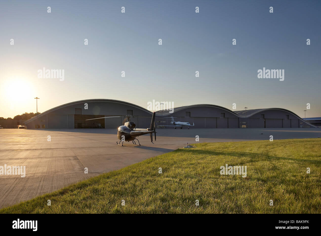 tag farnborough airport view of hangars into setting sun Stock Photo ...