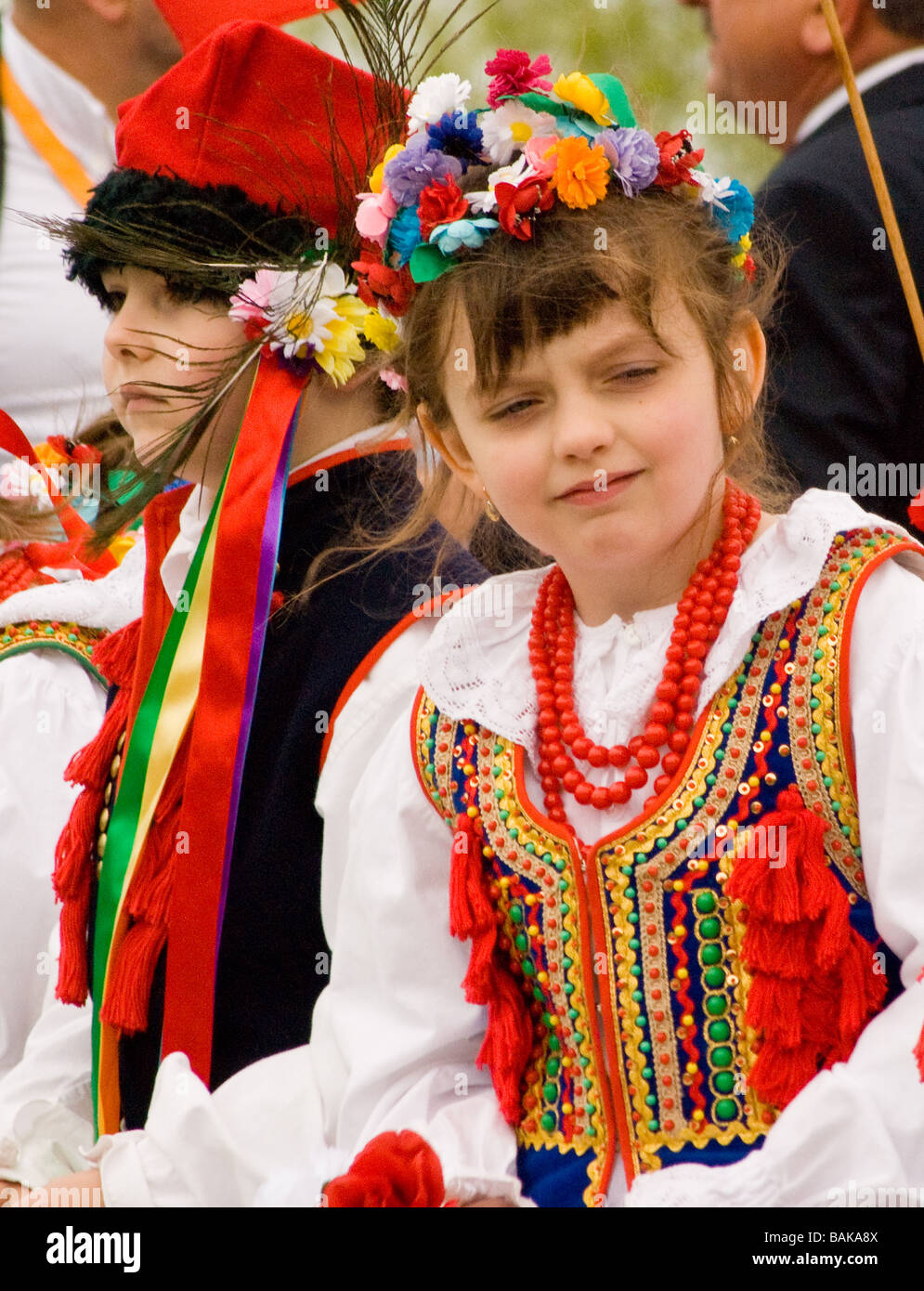 Girl wearing traditional clothing complete with wreath and necklace ...