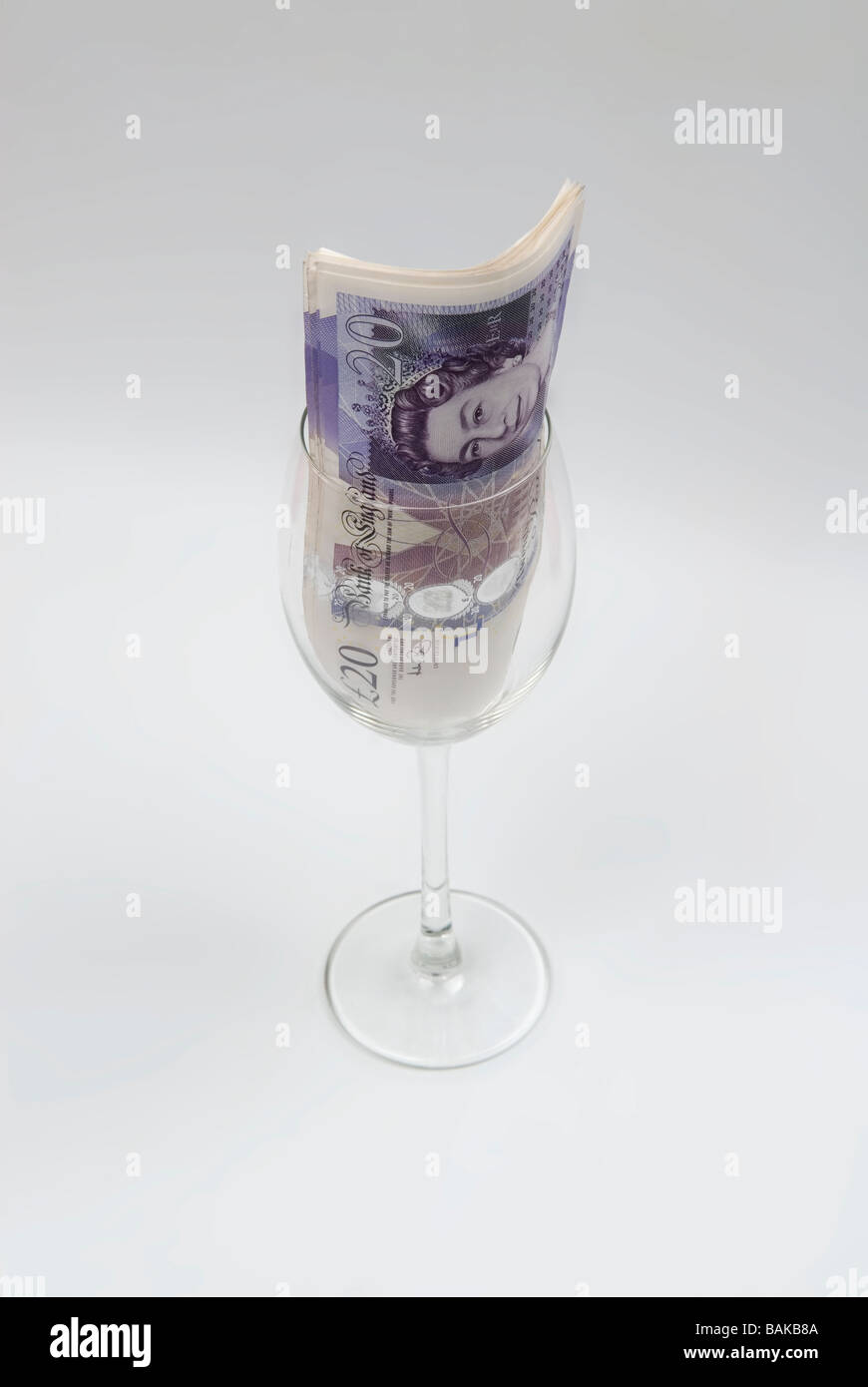 Money inside drinking glass Stock Photo - Alamy