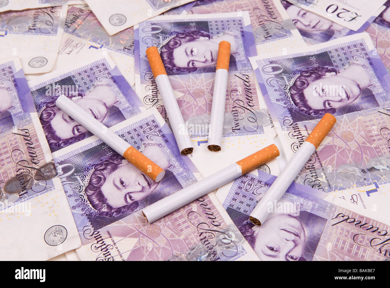 Cigarettes over British Money Stock Photo - Alamy
