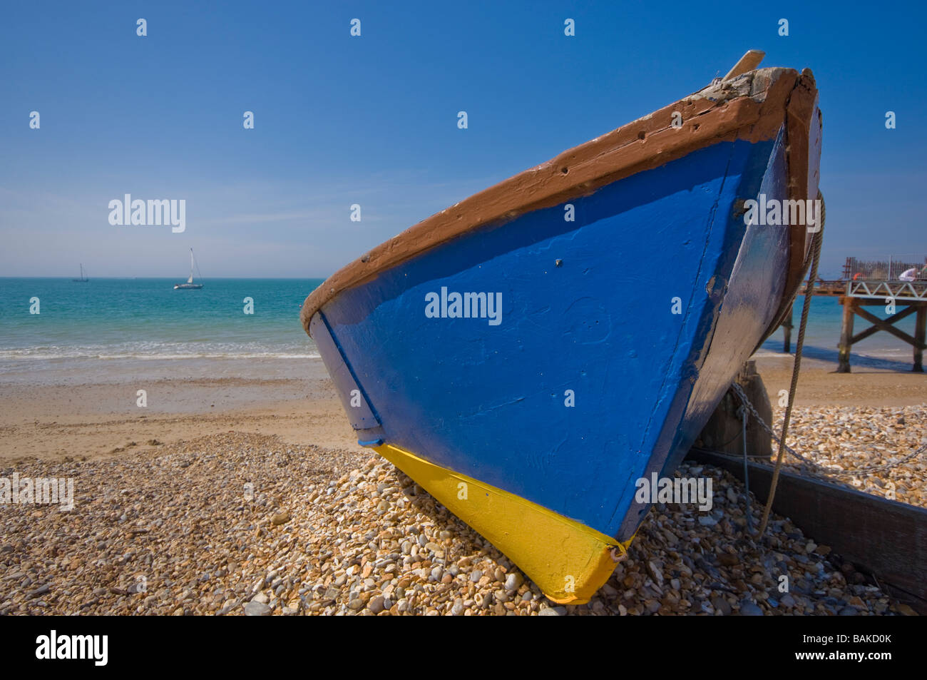 Blue rowboat sitting on the beach at Totland on the Isle of Wight Stock ...