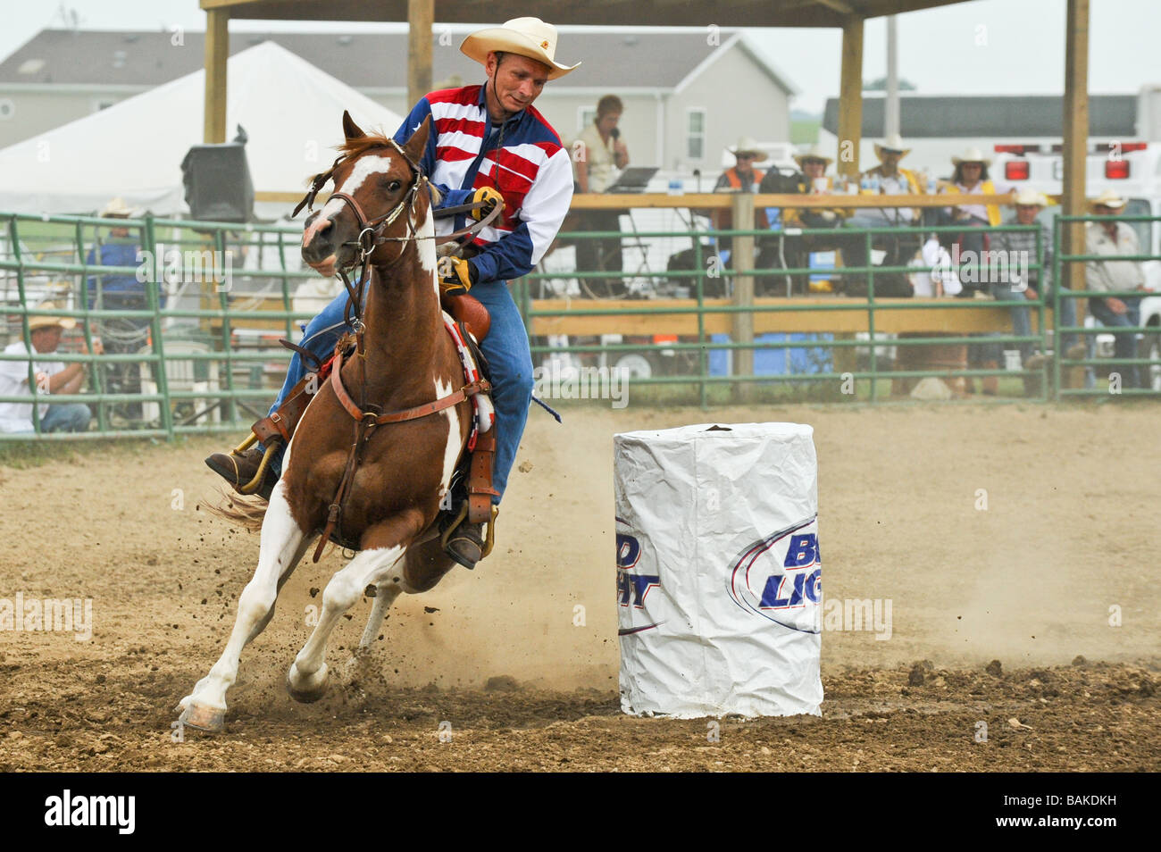 man riding running horse in barrel race at rodeo Stock Photo - Alamy