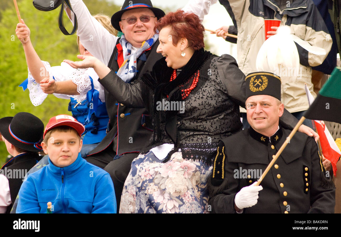 People riding a float greet and wave flags in Chicago Polish Parade ...