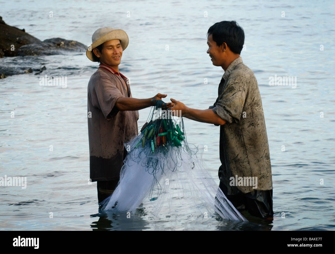 Fishermen catch fish near the shore using nets Stock Photo - Alamy