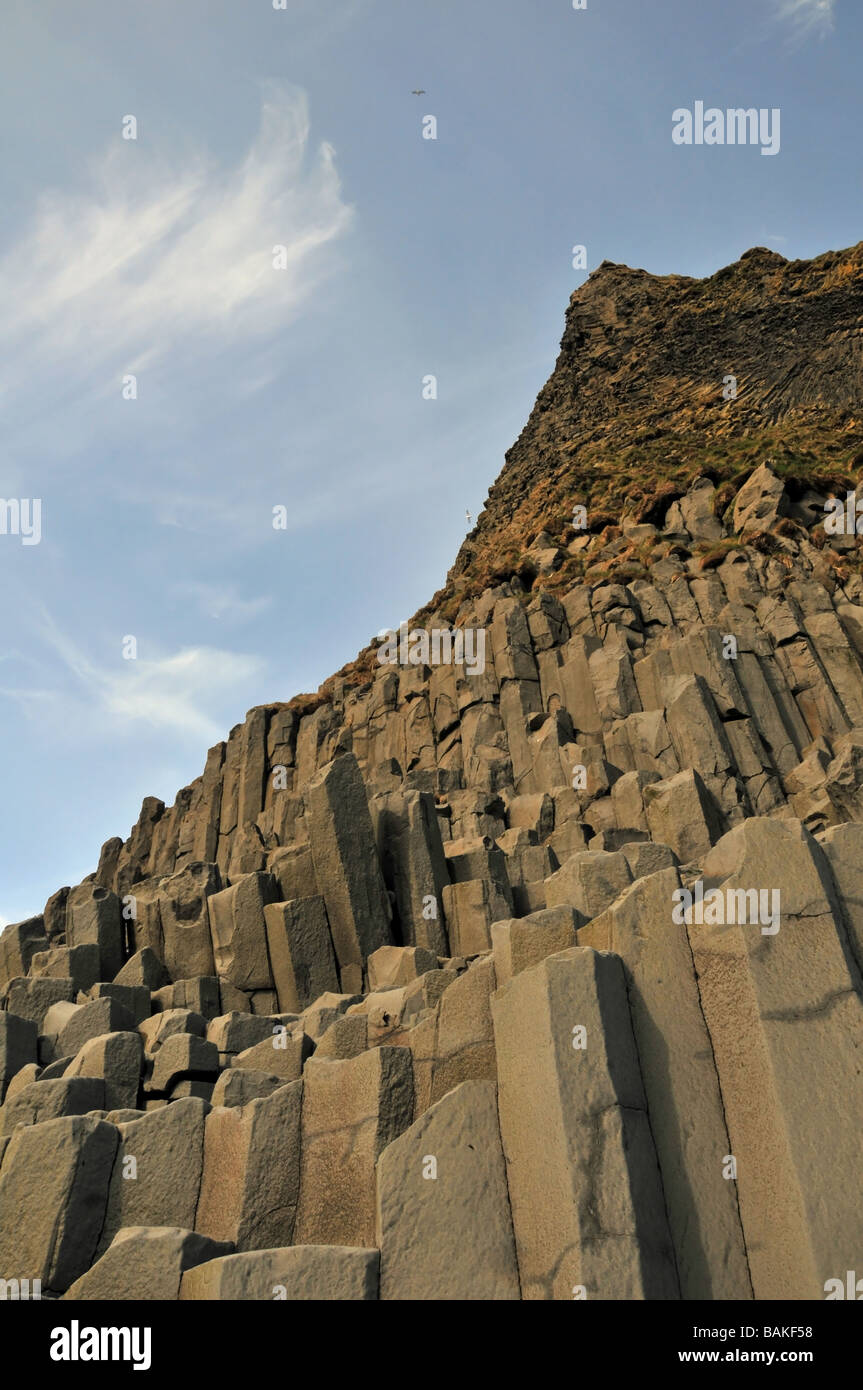 Impressive basalt columns rising skywards in the cliffs above the black ...