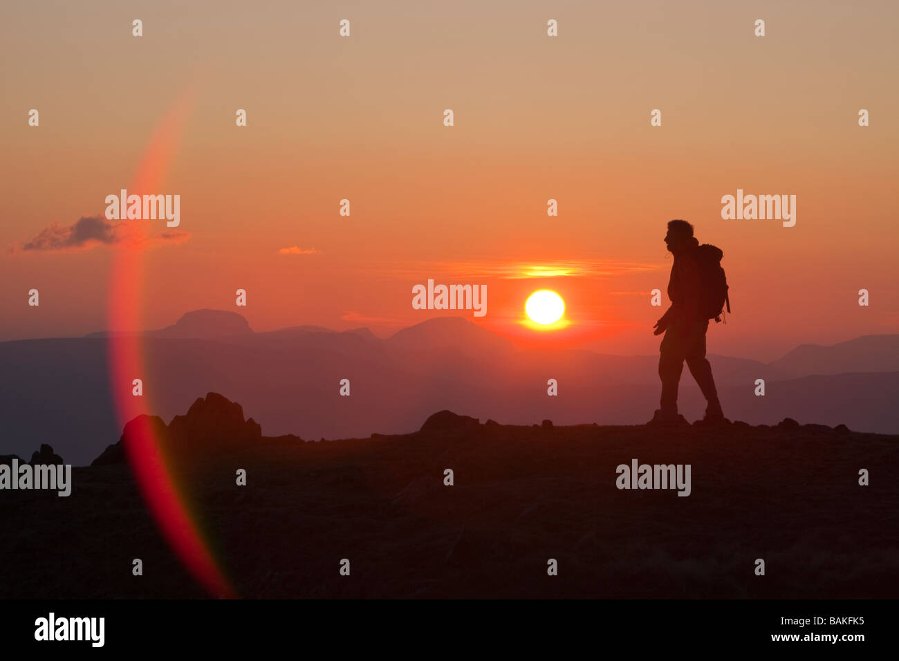 A walker on Red Screes in the Lake District at sunset UK Stock Photo ...