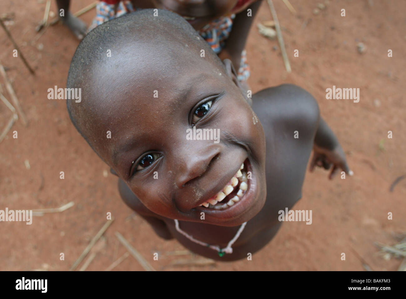 Local child giving a big smile for the camera in the small West African ...