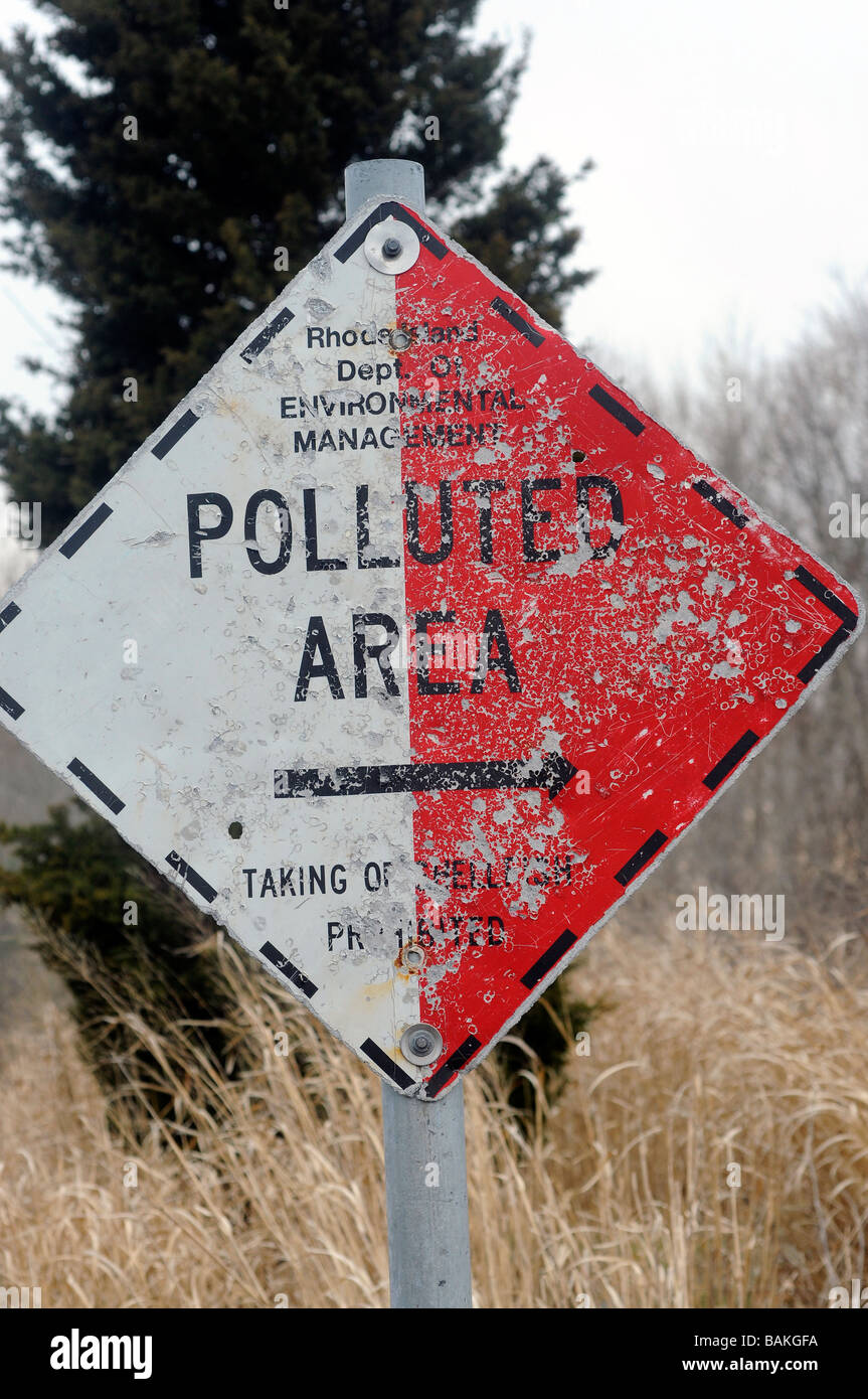 Sign along water designated separation between polluted and clean area ...