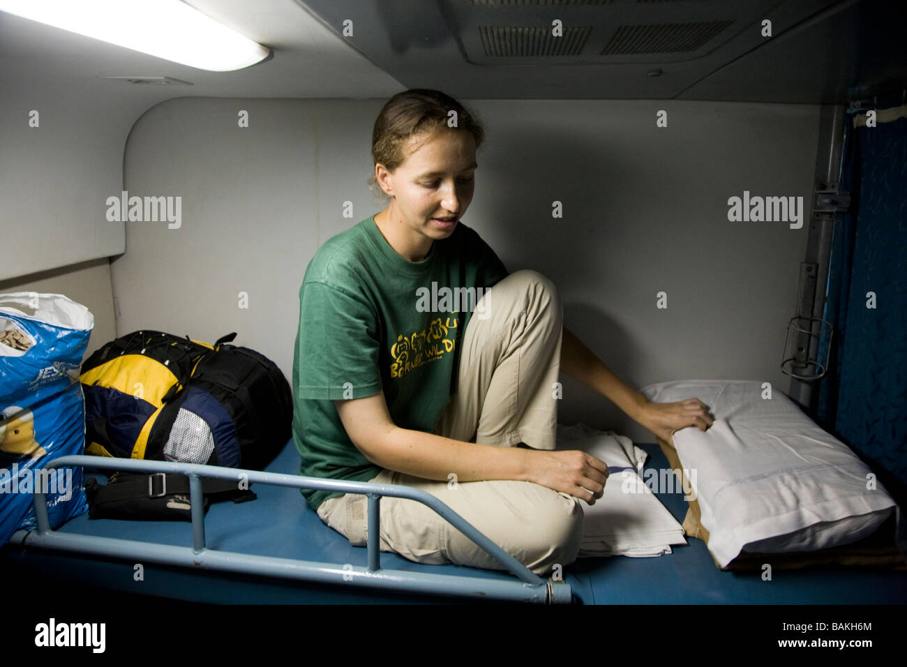 Western European passenger makes her bed in a second class sleeper ...