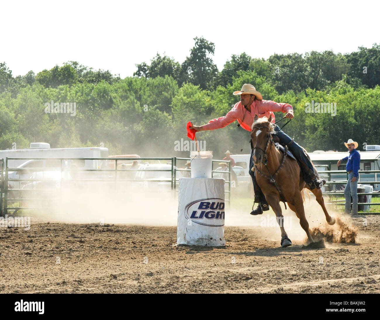 Horse rider participating in flag barrel race event at rodeo Stock ...