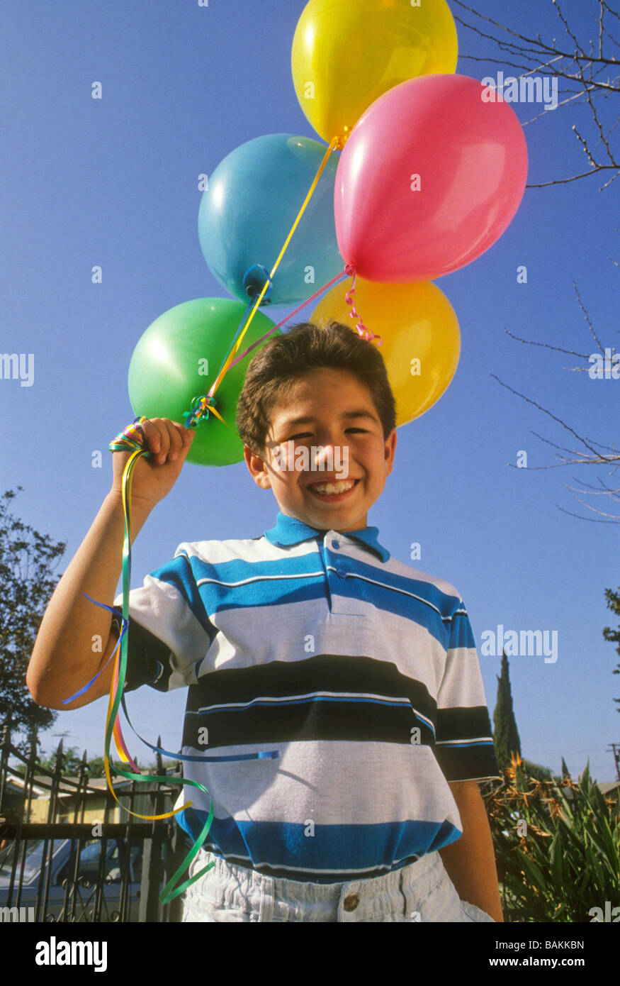 Hispanic boy batch balloon smile happy fun blue sky pleasant good time ...