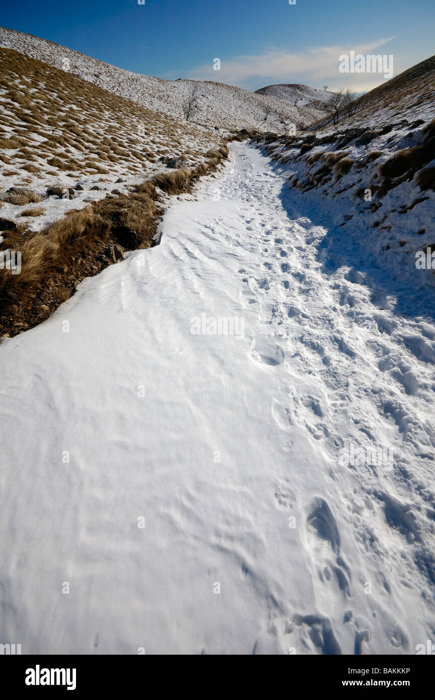 Pathway in mountain, footprints in a snow, clear day Stock Photo - Alamy