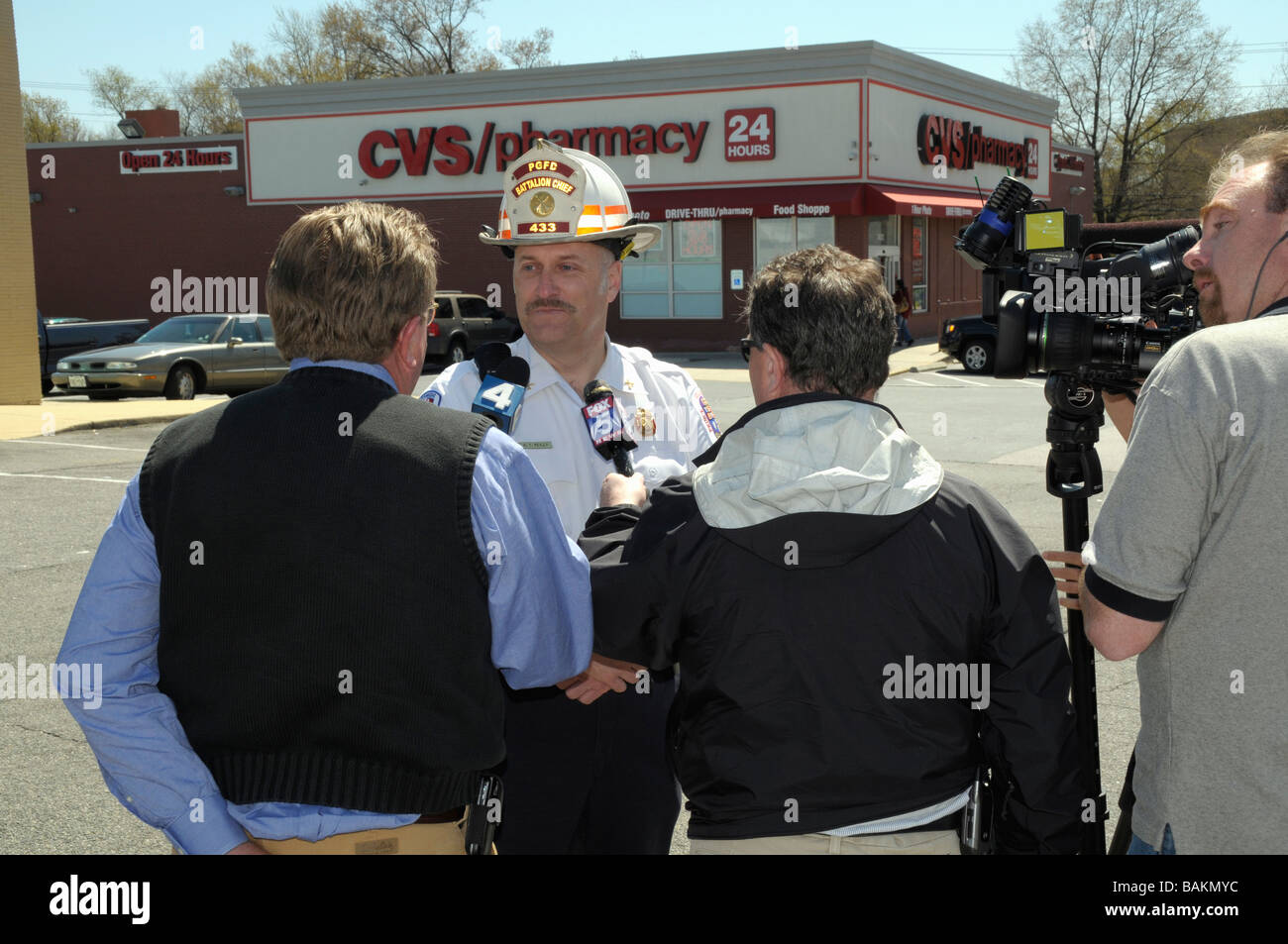 The media interviews a fire chief at the scene of an emergency in ...